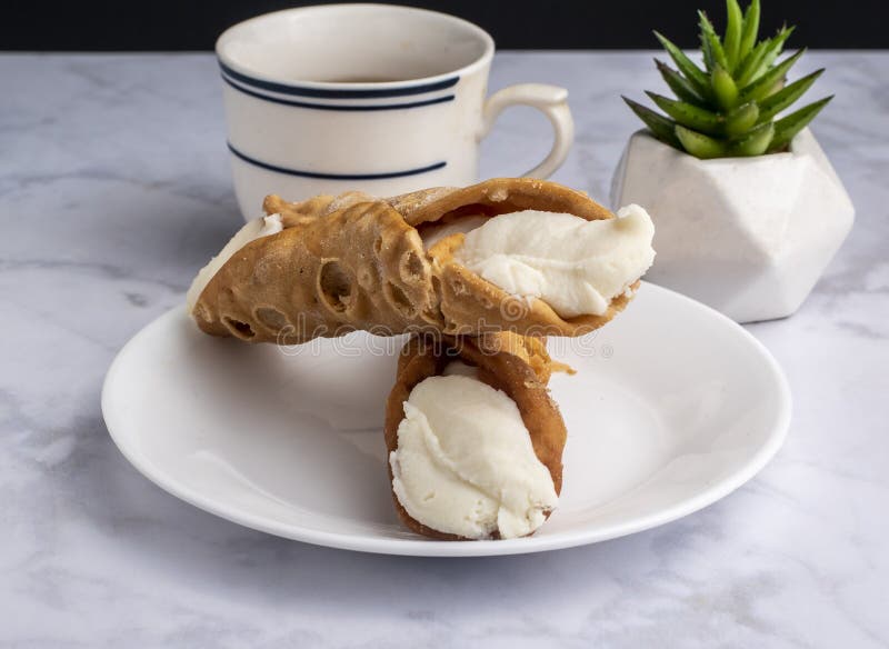 Two Cannolis Arranged on a Plate with a Cup of Tea Stock Photo - Image ...