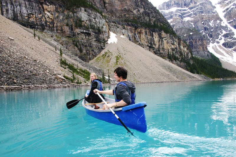 Two canoers stock image. Image of girl, tree, blue, canoe - 16391315