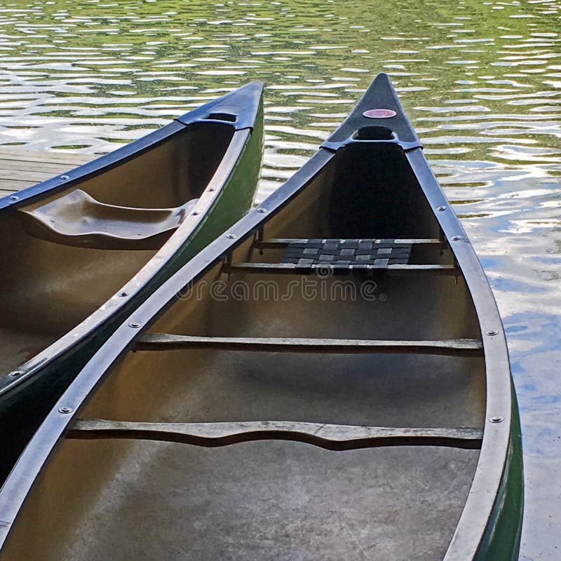 Two canoes on a lake stock image. Image of lake, canoe - 91656277