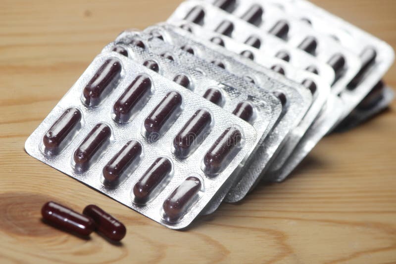 Two Capsule on Table with Capsule Blister Pack Stock Image - Image of ...