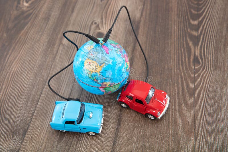 Two Car Models on the Table are Connected with a Globe, Which Means To ...