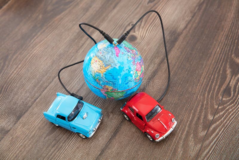 Two Car Models on the Table are Connected with a Globe, Which Means To ...