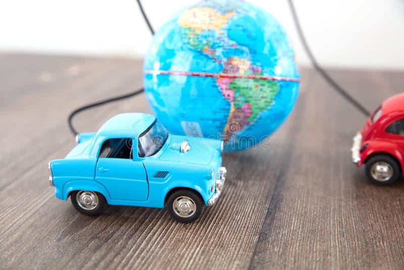 Two Car Models on the Table are Connected with a Globe, Which Means To ...