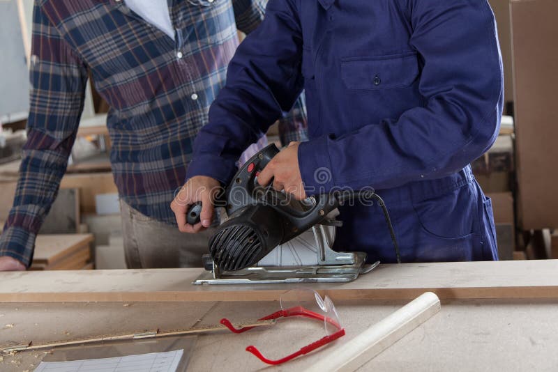 Two carpenters working stock image. Image of releases - 65259657