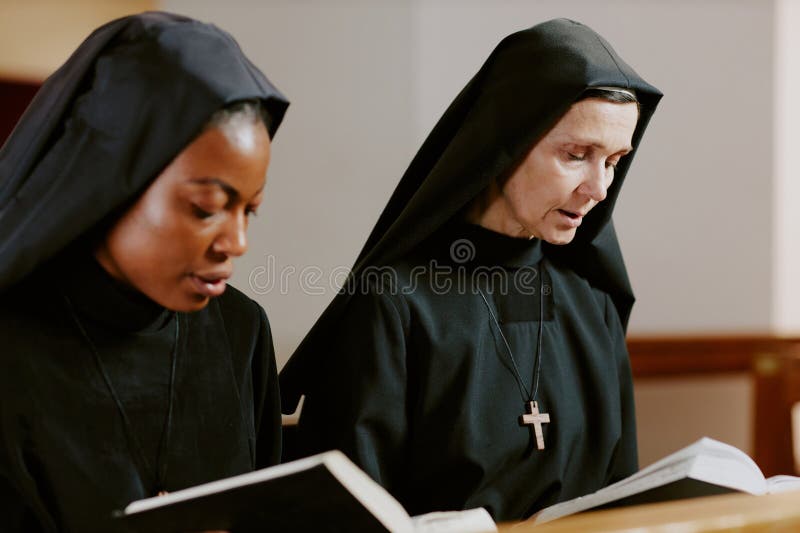 Two Catholic Nuns Praying stock photo. Image of read - 324505164