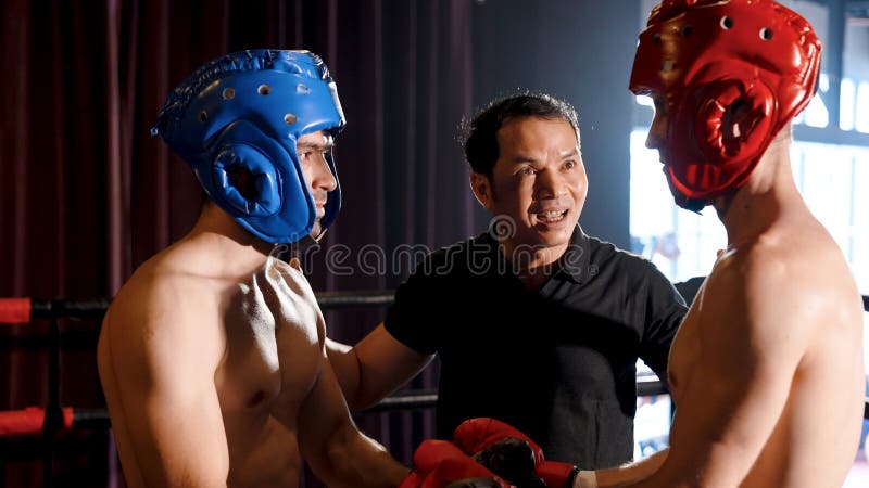 Two Caucasian Boxers, Red and Blue are Fighting. a Boxing Referee ...