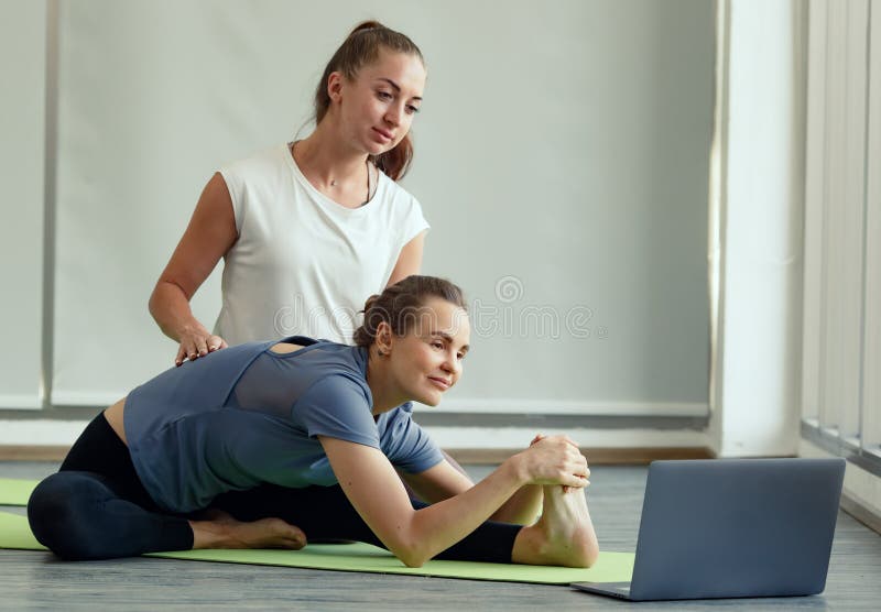 Two Caucasian Good Shape Female Yoga Learners Doing Body Stretches and ...