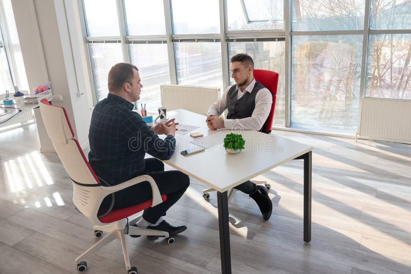 Two Caucasian Men Communicating at a Business Meeting. Stock Photo ...