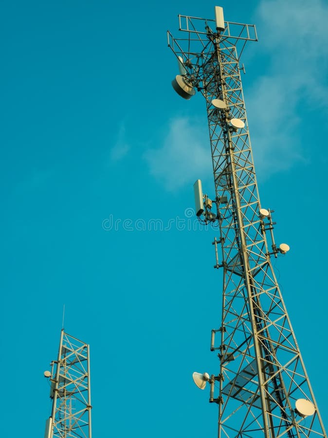 Two Cell Towers on a Background of Dry Grass and Blue Sky Stock Image ...