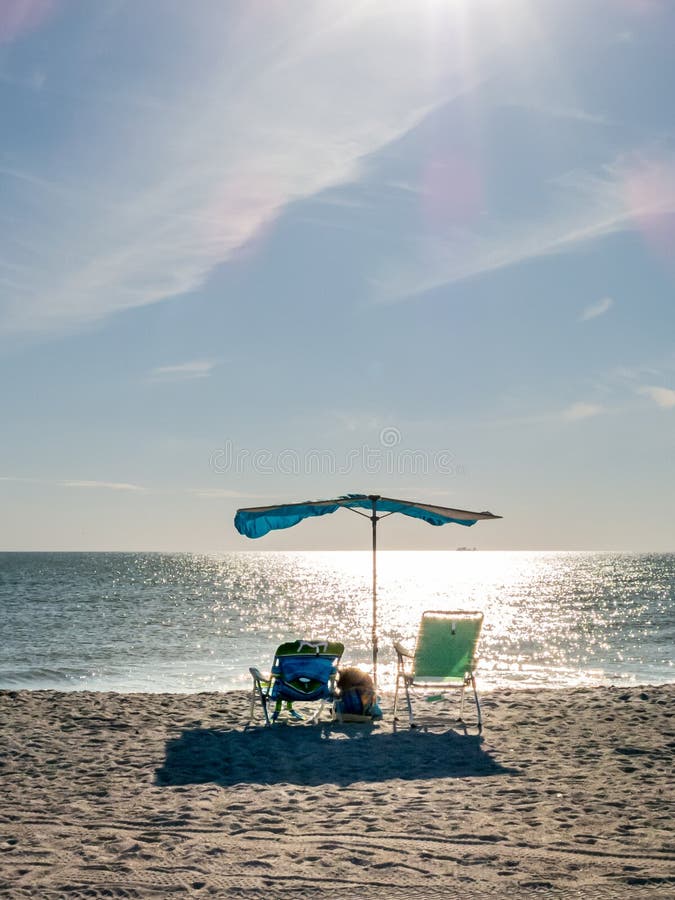 Two Chairs Facing the Ocean and Wind Driven Beach Shade Stock Image ...