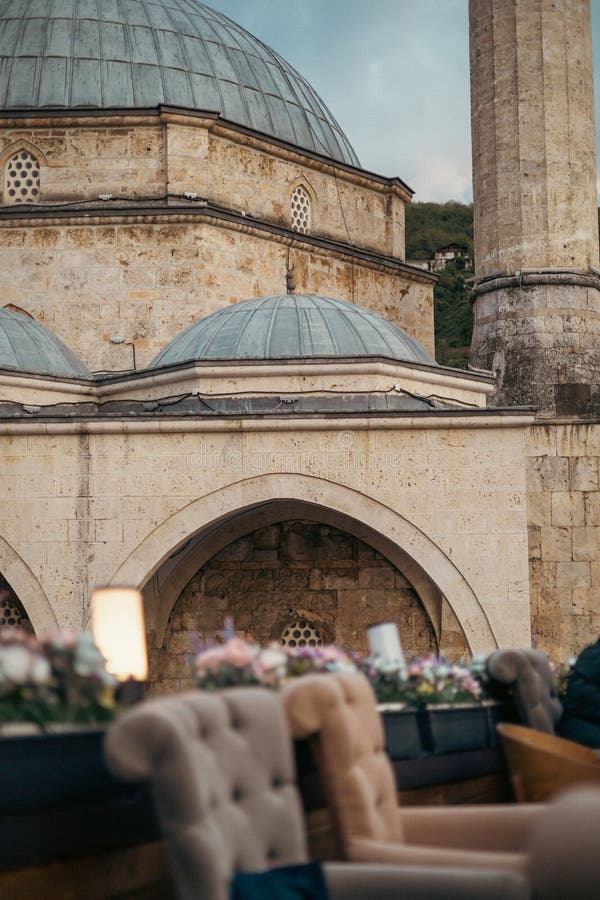 Two Chairs in Front of a Stone Building with Blue Domes and Windows ...