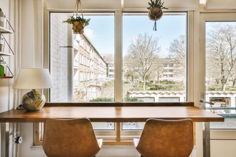 A Dining Room with a Large Window and a Table Stock Photo - Image of ...