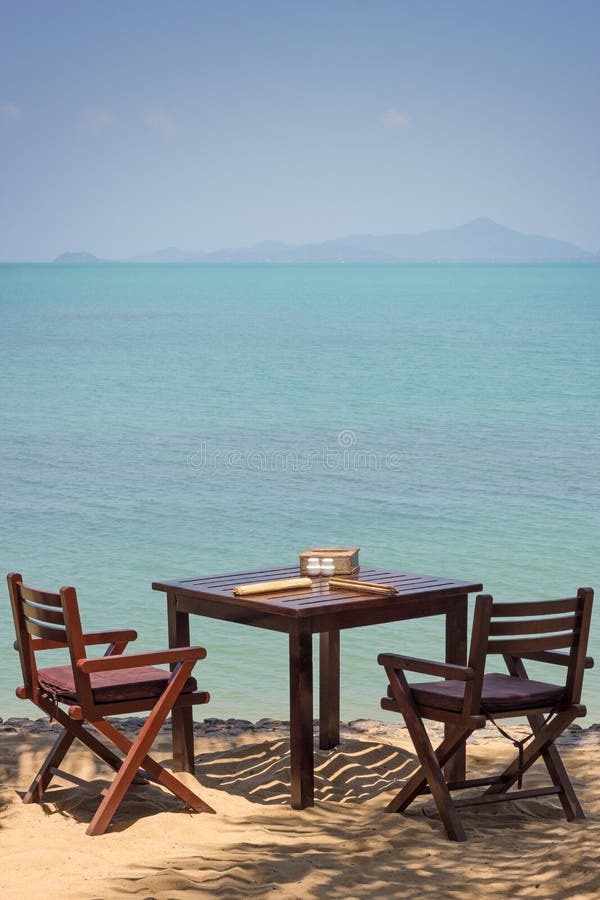 Two Chairs and Table at a Beach Close To Ocean Stock Photo - Image of ...
