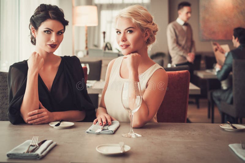 Two Charming Ladies in Elegant Evening Dresses in Restaurant Stock ...