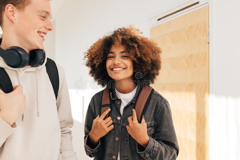 Two Cheerful Classmates Standing Together in Corridor Stock Photo ...