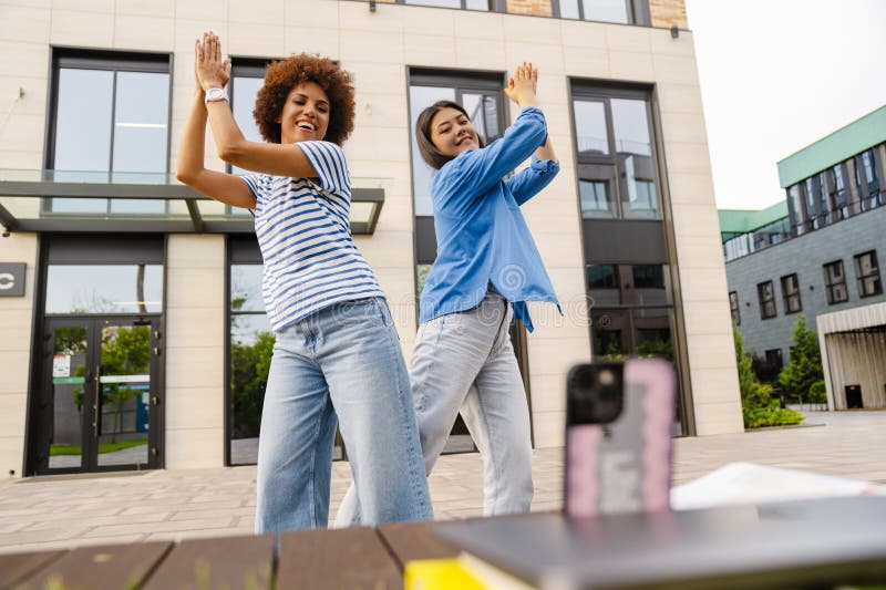 Two Cheerful Female Students Making Dancing Video by Smartphone Camera ...