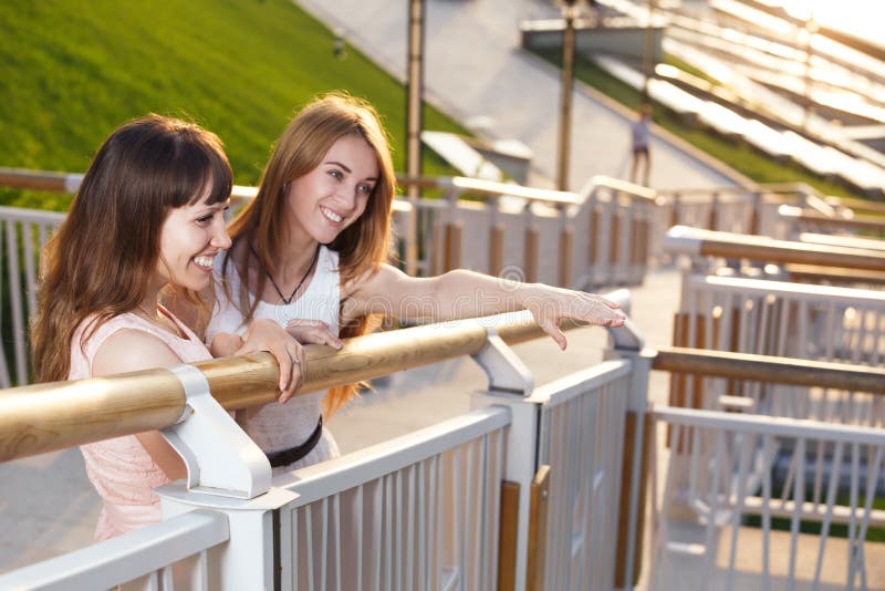 Two Cheerful Girls Stand on the Stairs Stock Image - Image of shopping ...