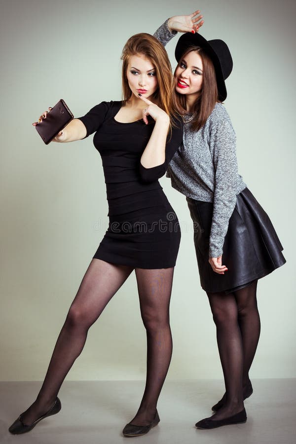Two Cheerful Happy Girl Girlfriends Photographed On The Phone Self