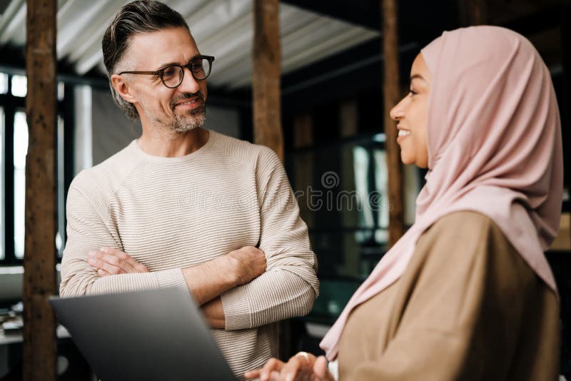 Two Multinational Colleagues Working with Laptop in Office Stock Image ...