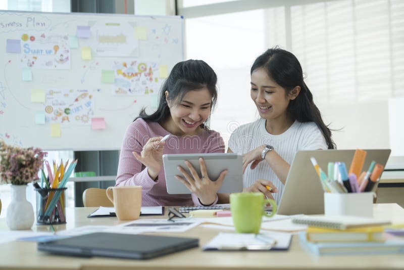 Two Cheerful Young Women are Sharing Information, Working on Project ...