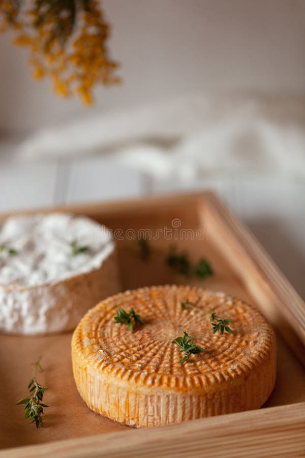 Two Cheese Types Decorated with Thyme Branches Served on a Wooden Tray ...