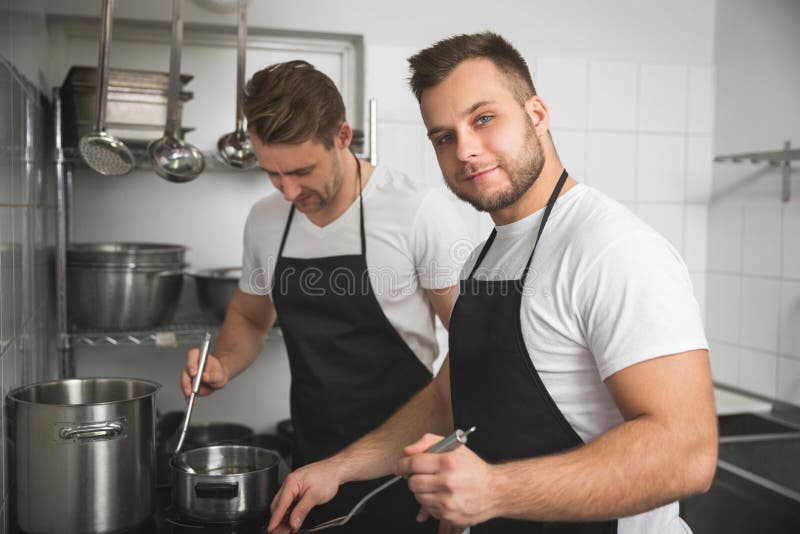 Two chef cooking together stock image. Image of caucasian - 83947037