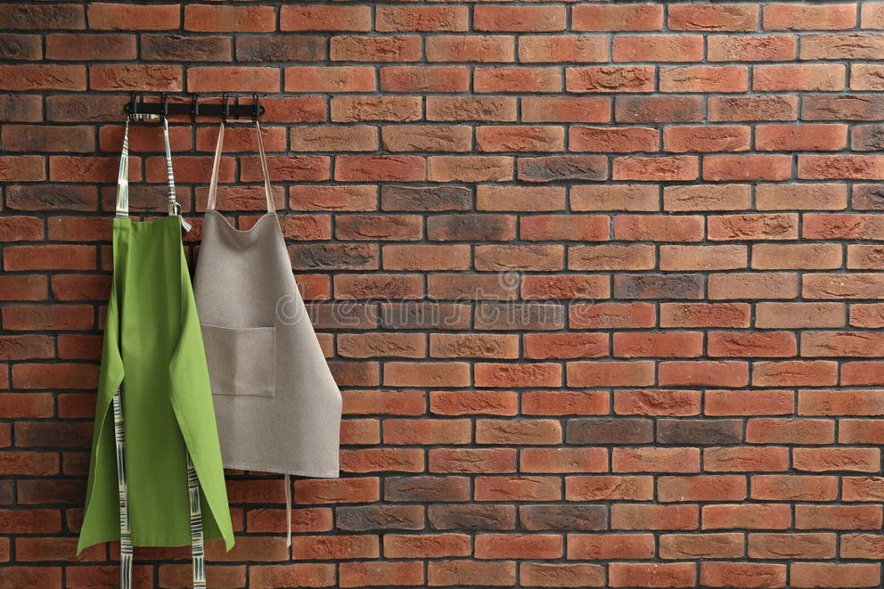 Two Chef S Aprons Hanging on Brick Wall, Space for Text Stock Image ...