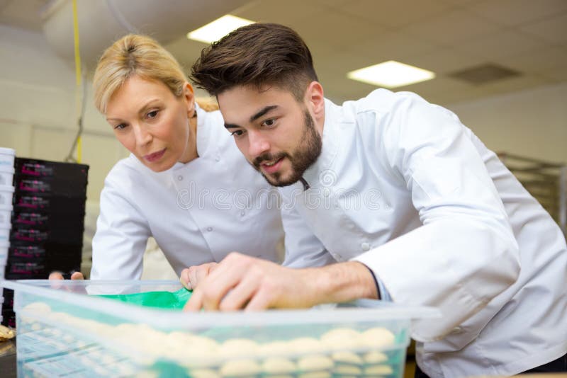 Man and Woman Chefs Cooking Food at Restaurants Kitchen Stock Photo ...