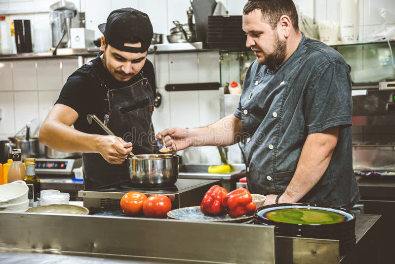 Two Chefs in the Restaurant Kitchen are Trying Food. Training Stock ...