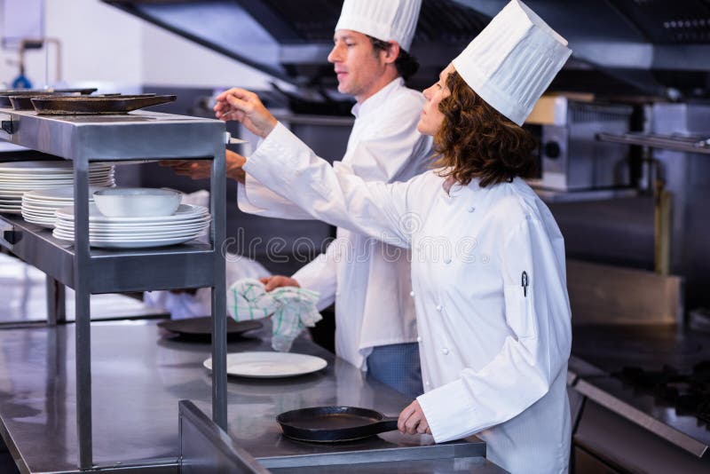Two Chefs Working at Order Station in a Kitchen Stock Image - Image of ...