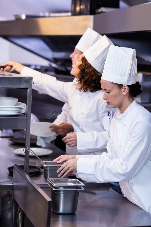 Two Chefs Working at Order Station in a Kitchen Stock Image - Image of ...