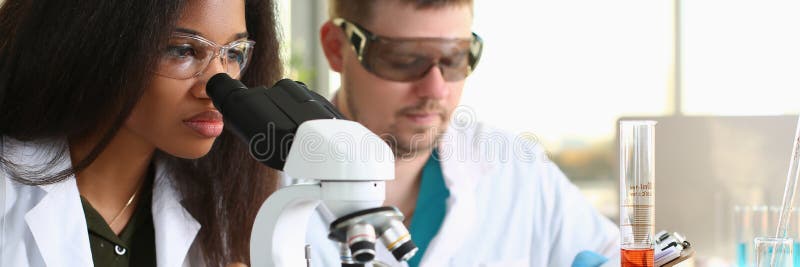 Two Chemistry Students Conduct Microscopic Examinations in Laboratory ...