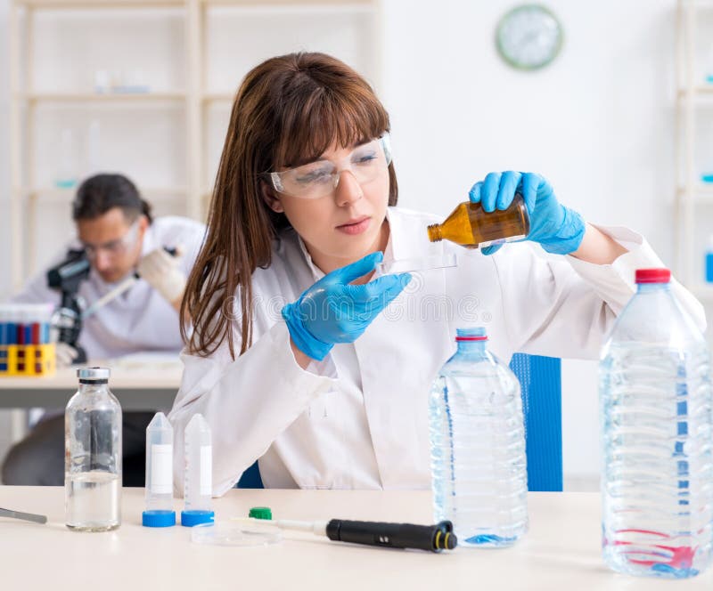 Two Chemists Working in the Lab Stock Photo - Image of filtered ...