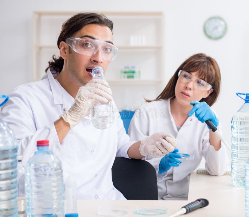Two Chemists Working in the Lab Stock Image - Image of filtered ...