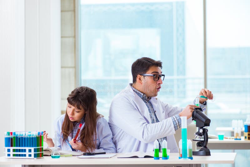 The Two Chemists Working in Lab Experimenting Stock Image - Image of ...