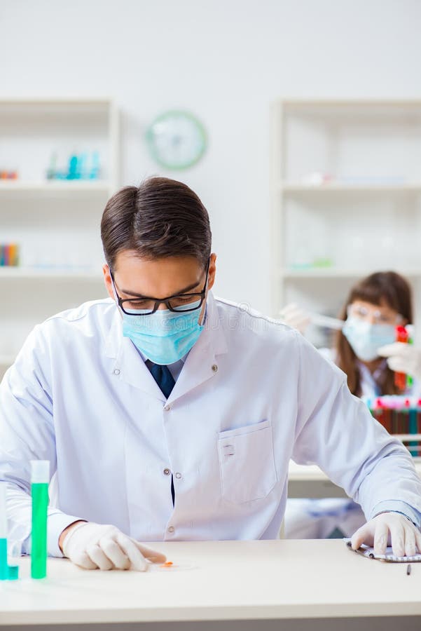The Two Chemists Working in Lab Experimenting Stock Photo - Image of ... The Two Chemists Working in Lab Experimenting Stock Photo - Image of ...