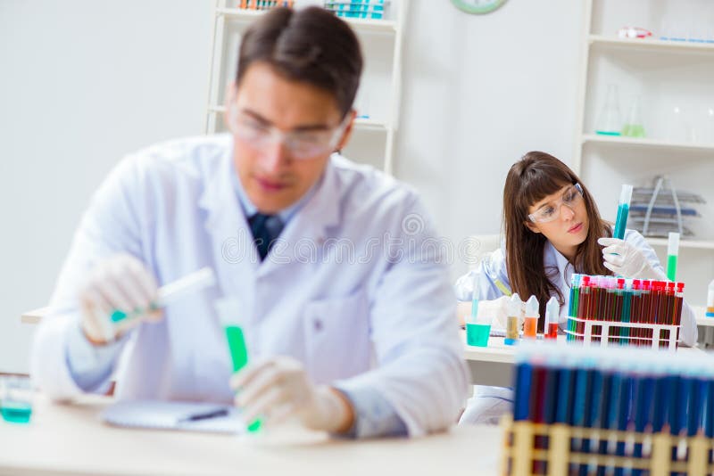 The Two Chemists Working in Lab Experimenting Stock Photo - Image of ...