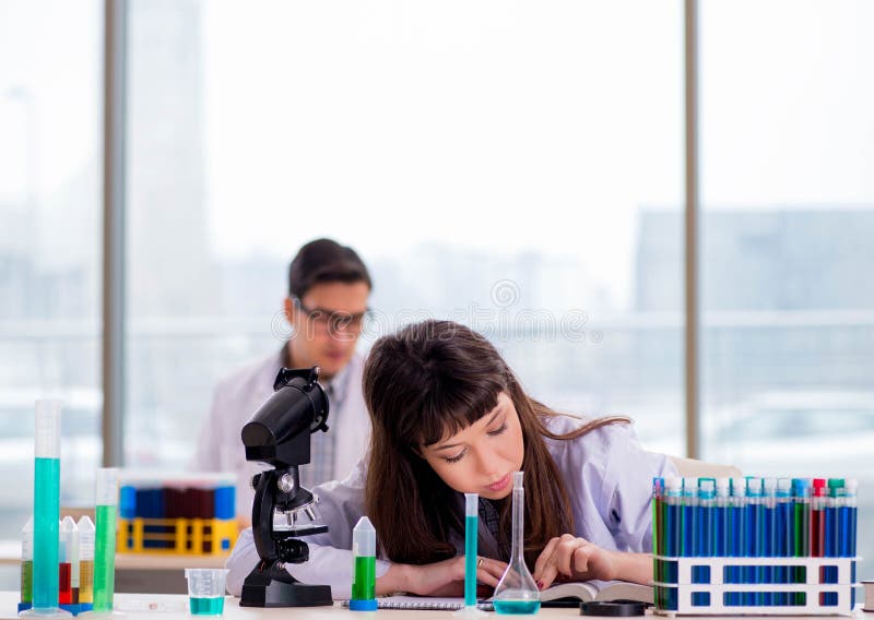 Two Chemists Working in Lab Experimenting Stock Photo - Image of ...