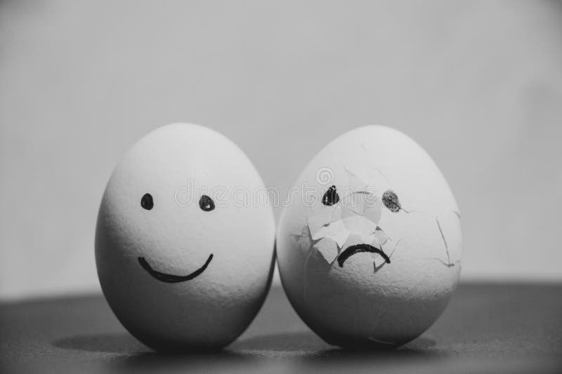 Two Chicken Eggs, One with Joy, and the Second Broken with Sad Emotions ...