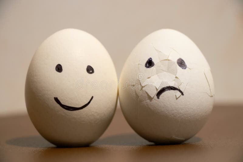 Two Chicken Eggs, One with Joy, and the Second Broken with Sad Emotions ...