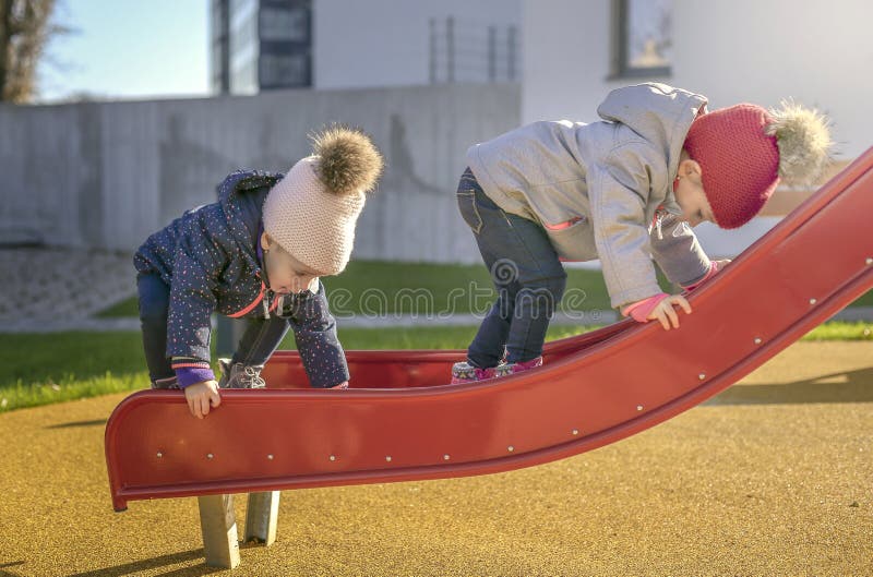 Two Children in Autumn Fall on the Playground Stock Photo - Image of ...