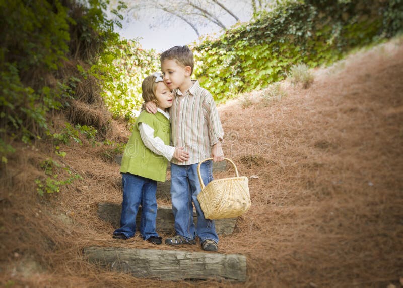 Two Children with Basket Hugging Outside on Steps Stock Image - Image ...