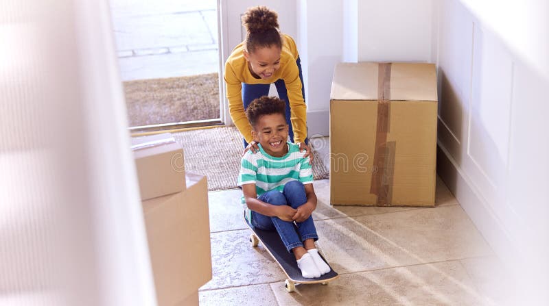 Two Children with Boxes on Moving in Day Playing on Skateboard Stock ...