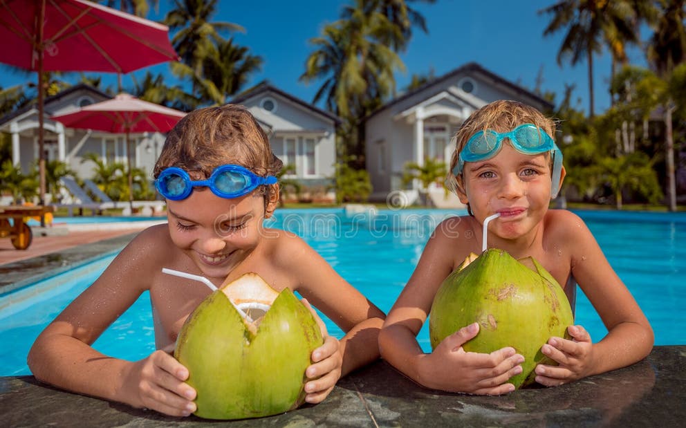 Two children with coconuts stock photo. Image of holidays - 67413752