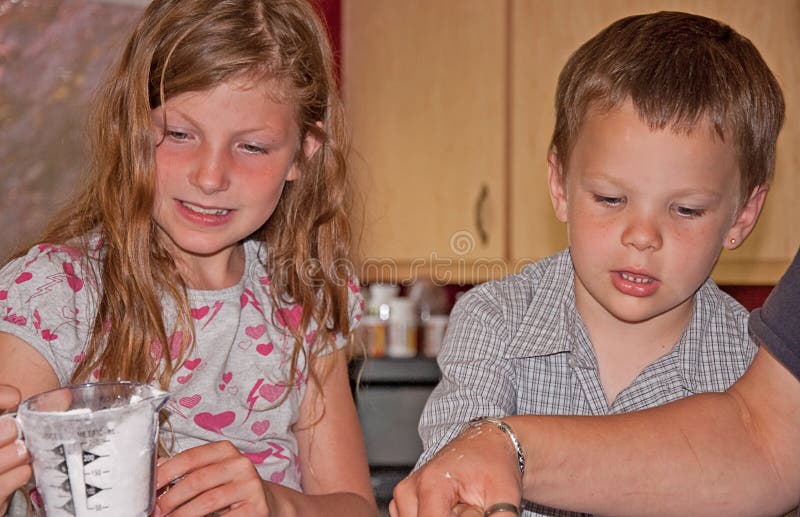 Two Children Cooking stock image. Image of measuring - 11351973