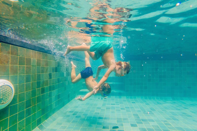 Two Children Diving in Masks Underwater in Pool Stock Image - Image of ...