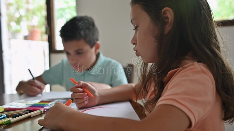 Children Engaged in Drawing with Pens and Markers at Home, Focused on ...
