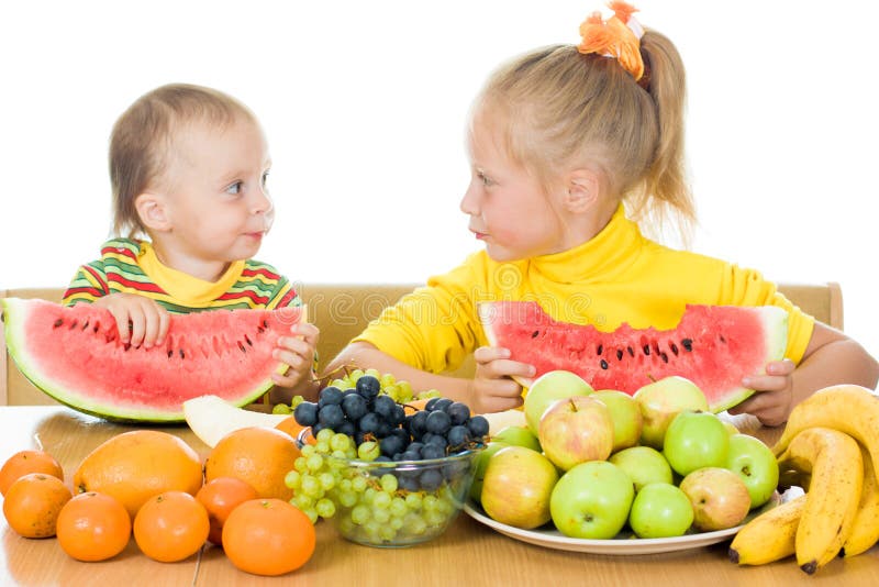 Two Children Eat Fruit at a Table Stock Photo - Image of child, baby ...