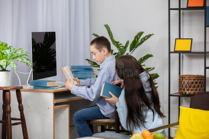 Children Engage in Home Learning, Using Books and Computers for Their ...