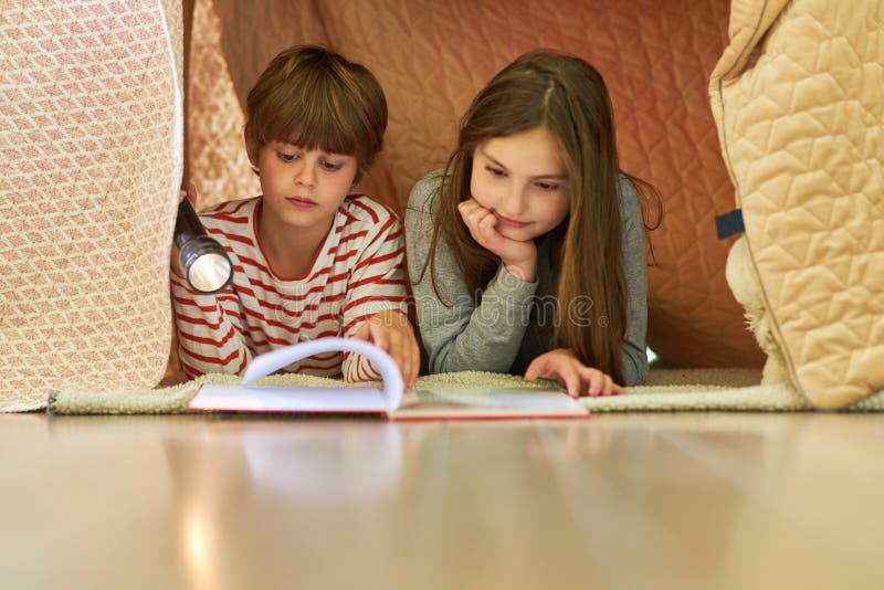 Two Children with Flashlight Read a Book Stock Image - Image of girl ...